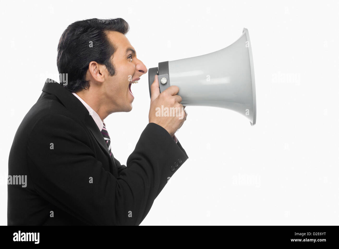 Businessman shouting into a megaphone Stock Photo - Alamy