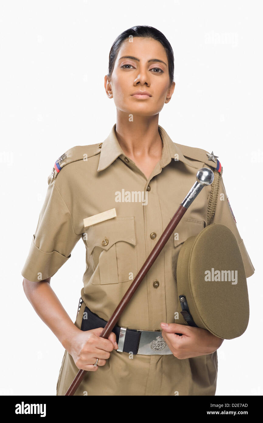 Portrait of a female police officer holding a stick Stock Photo - Alamy