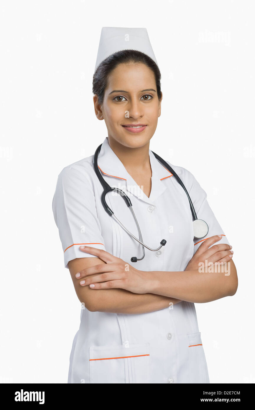 Female nurse standing and smiling Stock Photo - Alamy