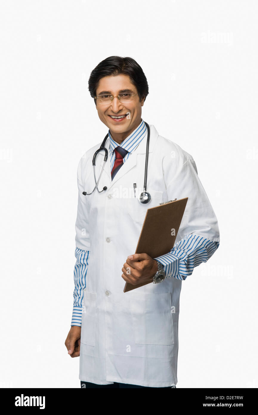 Portrait of a doctor holding a clipboard and smiling Stock Photo - Alamy