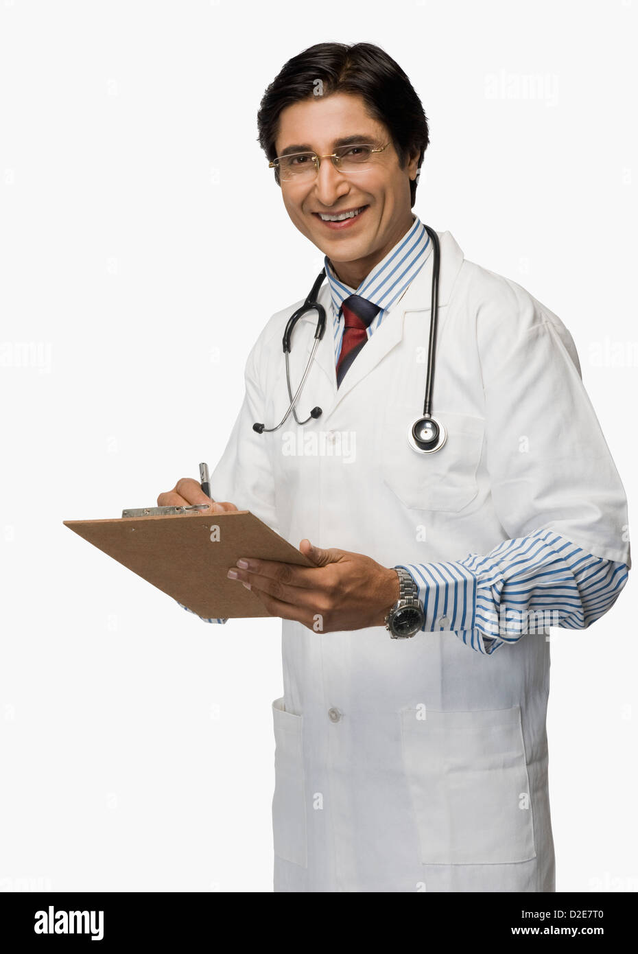 Portrait of a doctor writing on a clipboard and smiling Stock Photo - Alamy