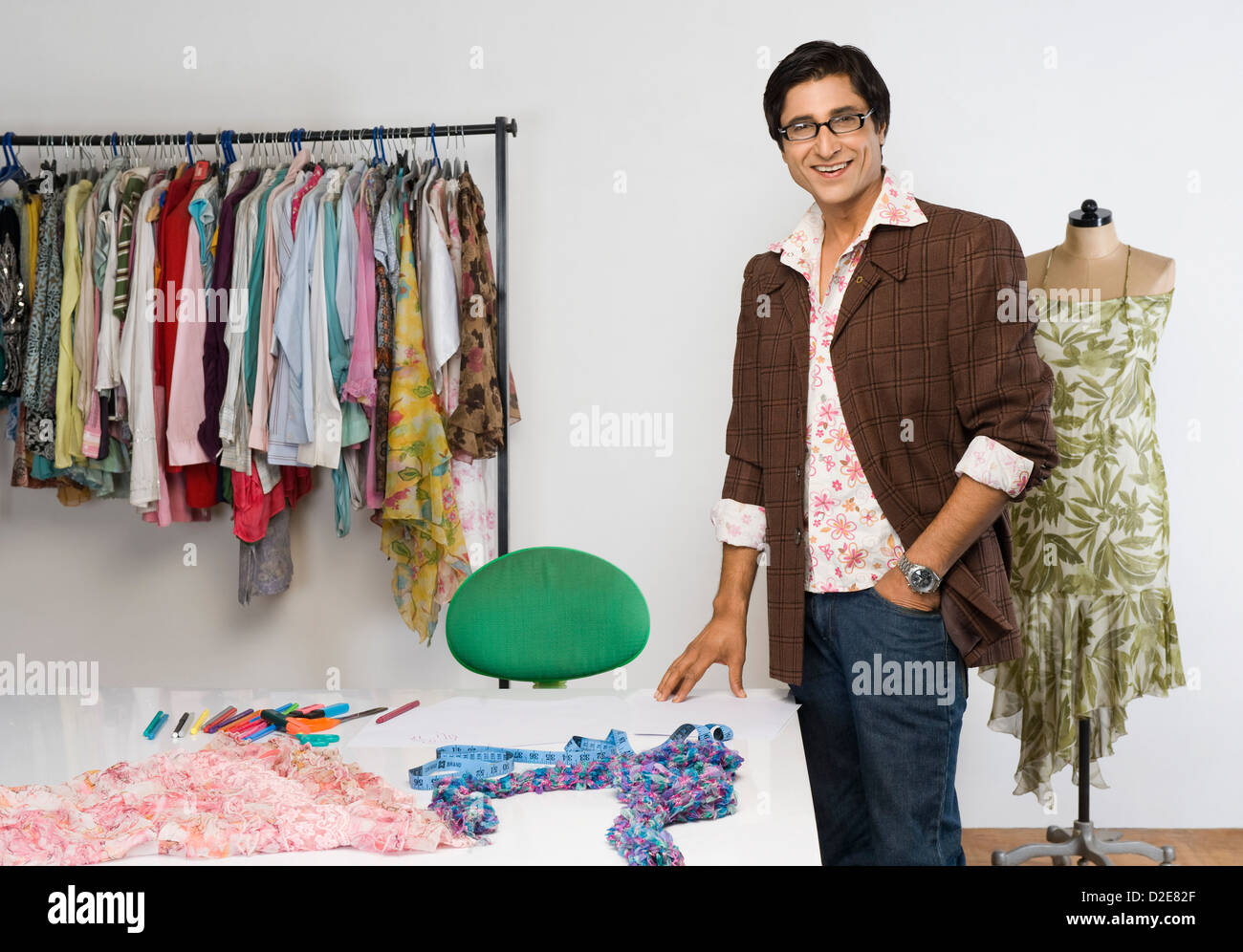 Portrait of a tailor standing in a clothing store and smiling Stock ...