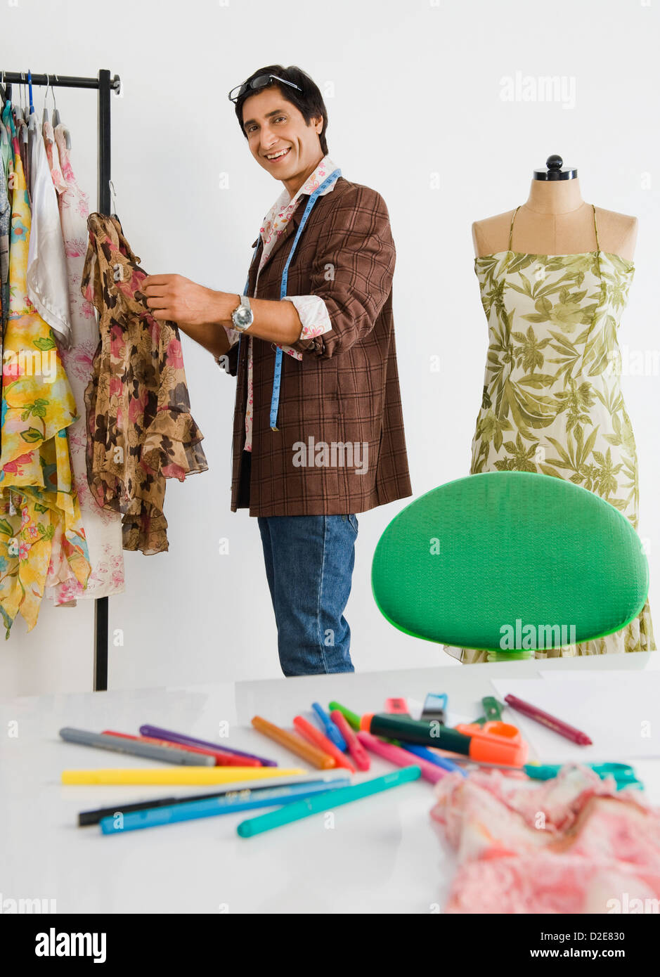 Tailor working in a clothing store and smiling Stock Photo - Alamy
