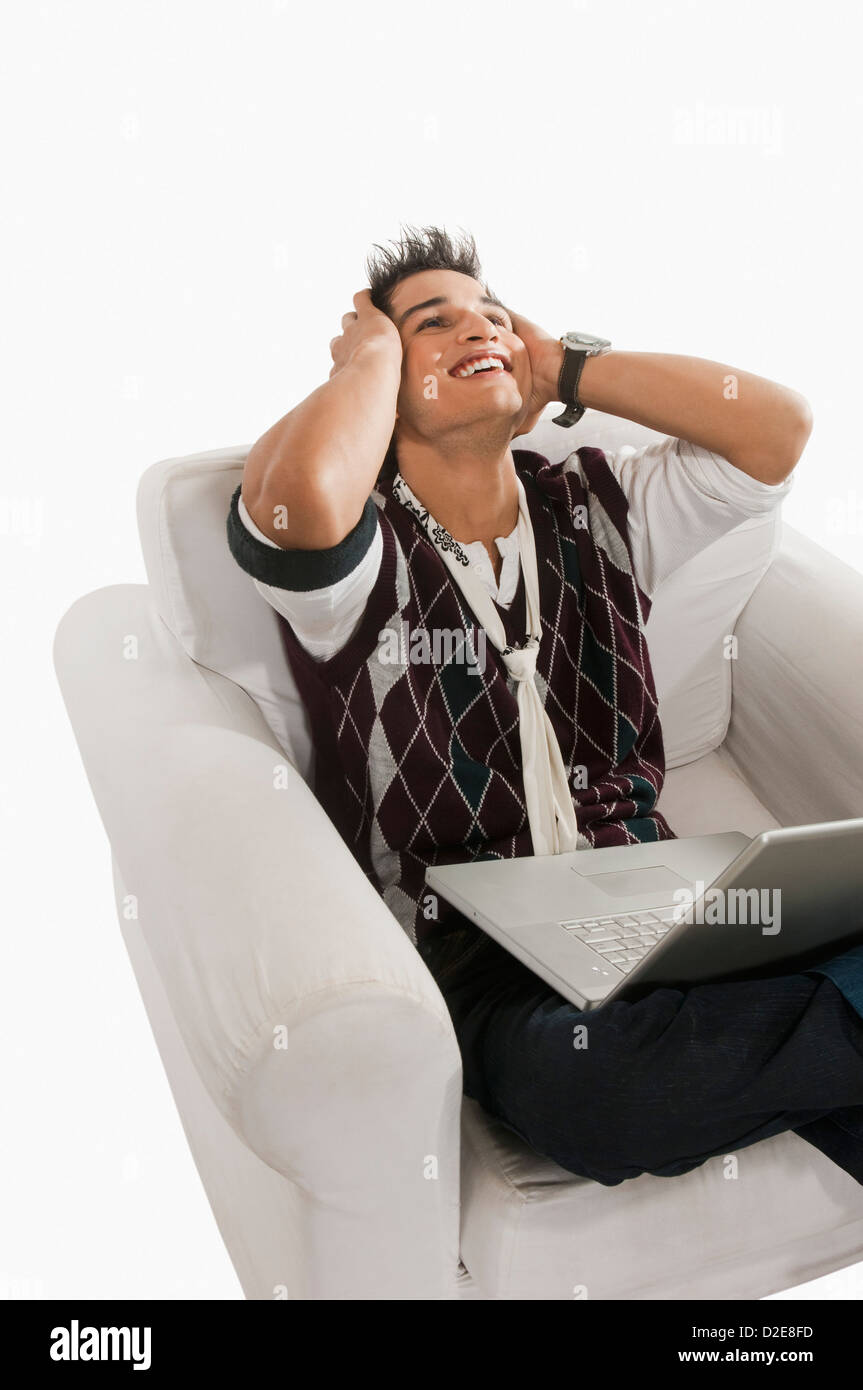 Close-up of a man looking excited while using a laptop Stock Photo - Alamy