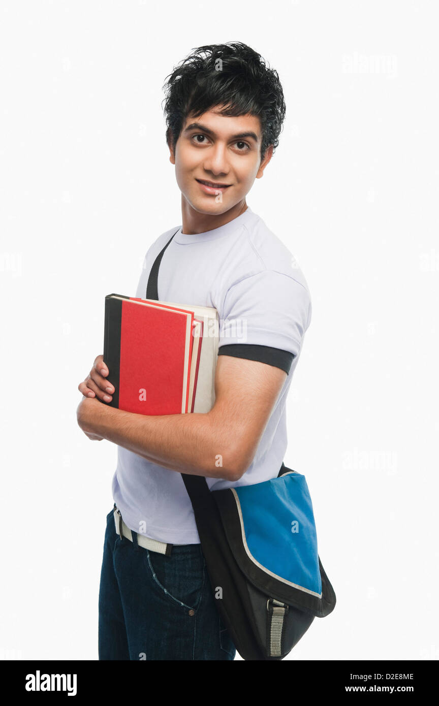 Portrait of a college student holding notebooks Stock Photo - Alamy