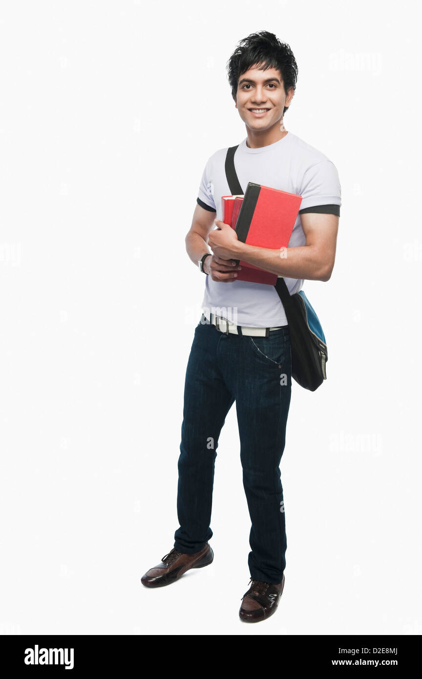 Portrait of a college student holding notebooks Stock Photo - Alamy