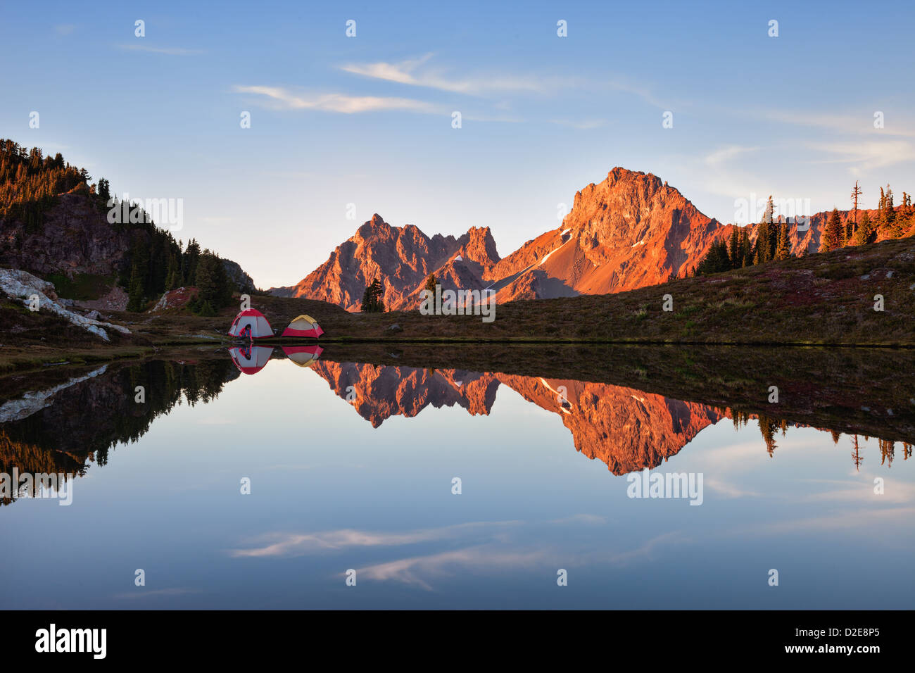 Rugged Peaks in Sunset Glow and Reflected in Tarn with Hiker and Tents ...