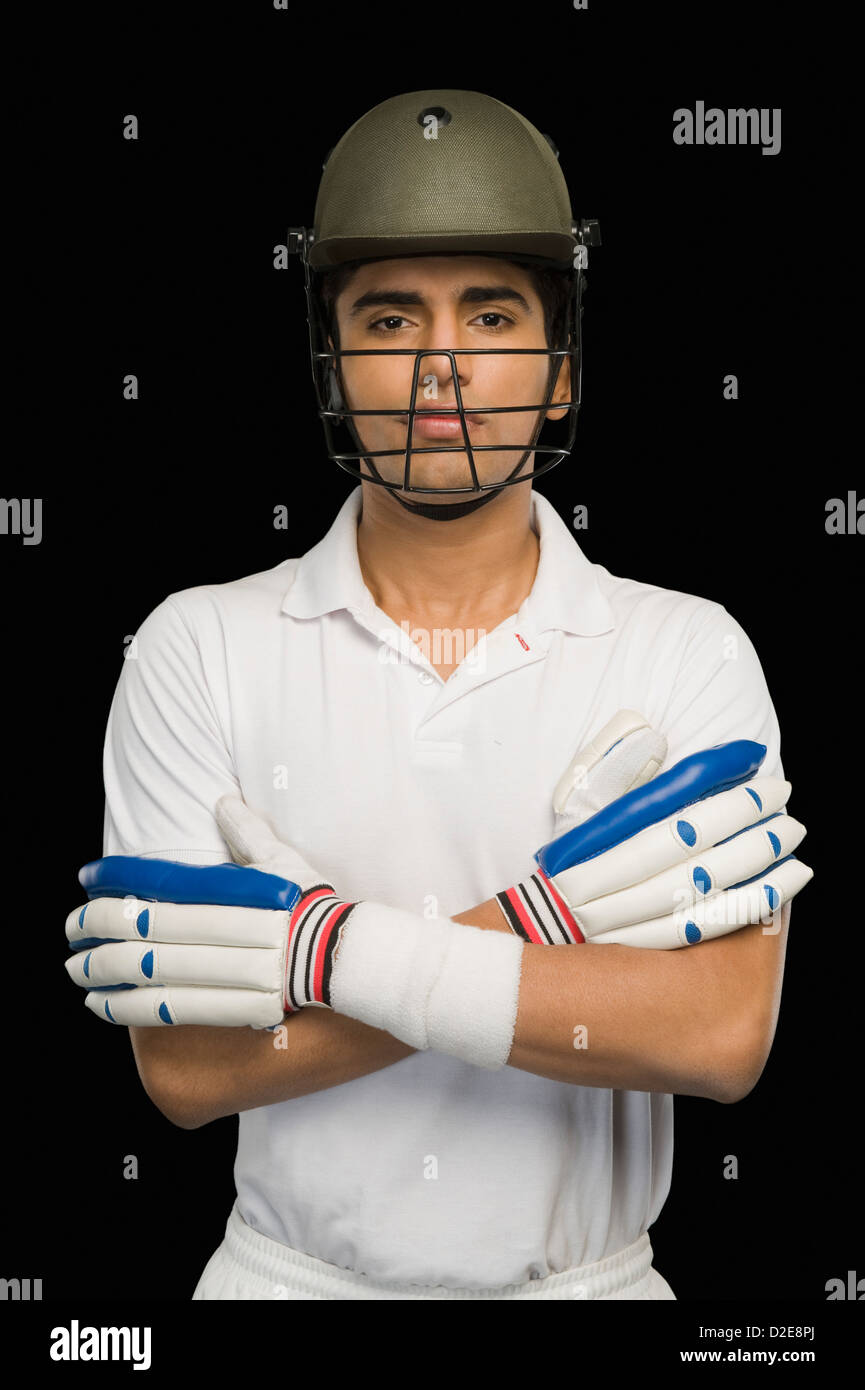 Portrait of a cricket batsman with arms crossed Stock Photo - Alamy