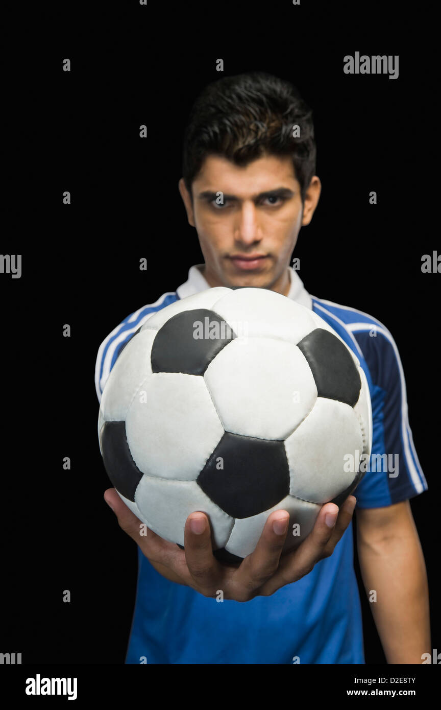 Soccer player showing a soccer ball Stock Photo - Alamy