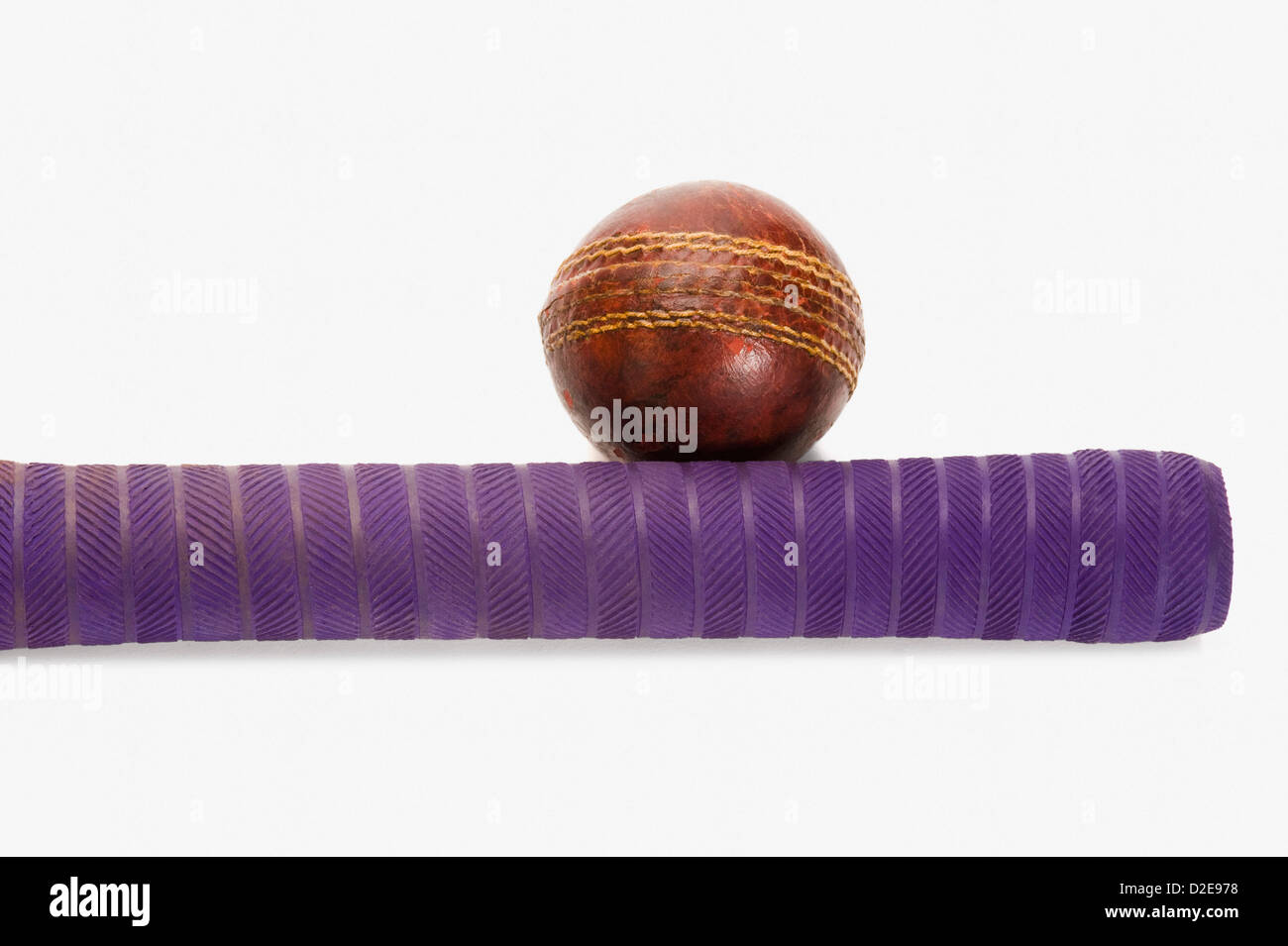 Close-up of a cricket ball with a bat Stock Photo - Alamy