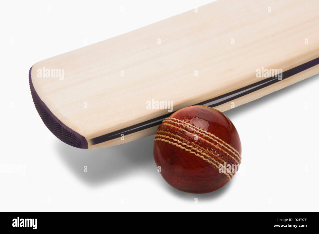 Close-up of a cricket ball with a bat Stock Photo - Alamy