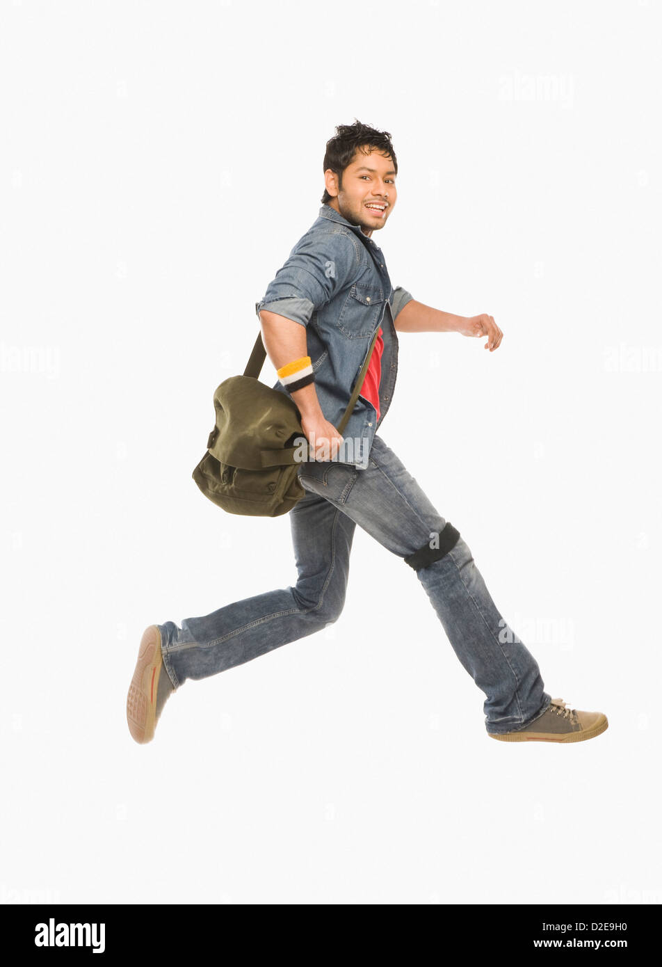 University student running with a shoulder bag Stock Photo - Alamy