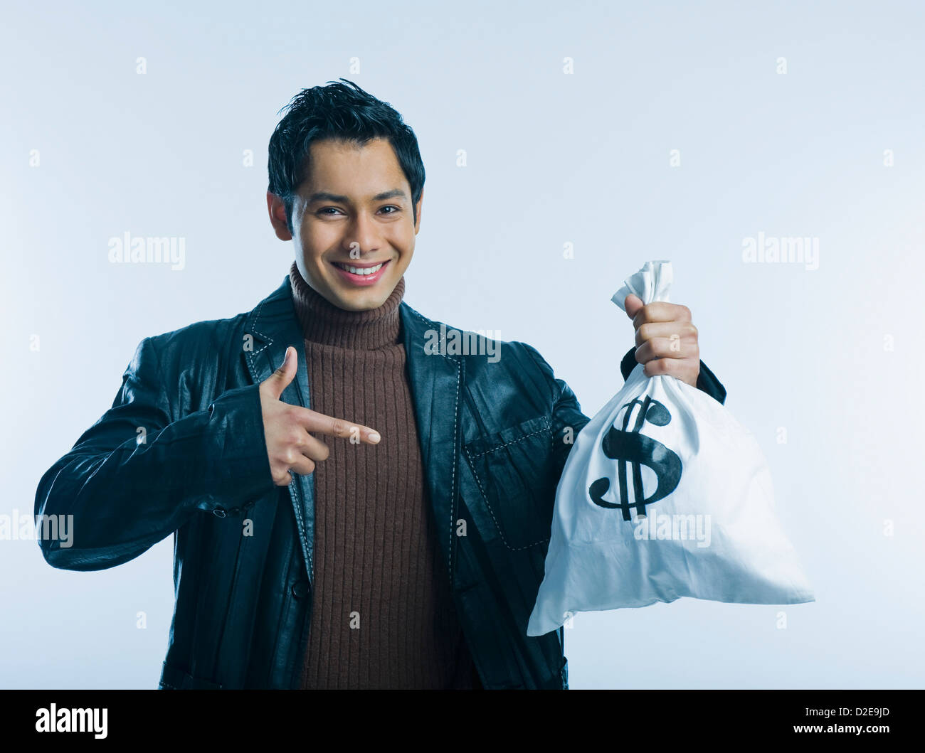 Portrait of a man holding a money bag Stock Photo - Alamy