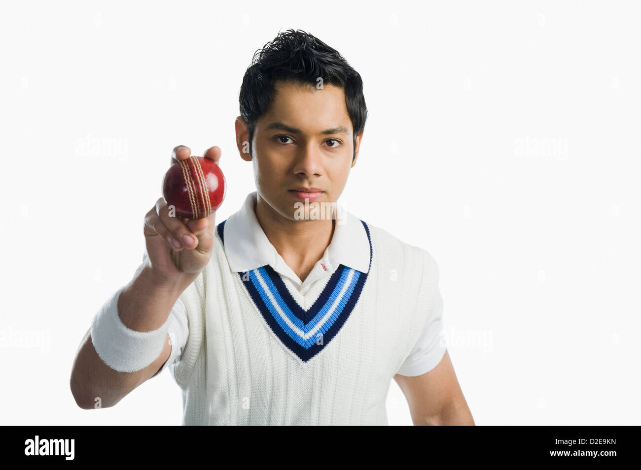 Portrait of a cricket bowler holding a ball Stock Photo - Alamy