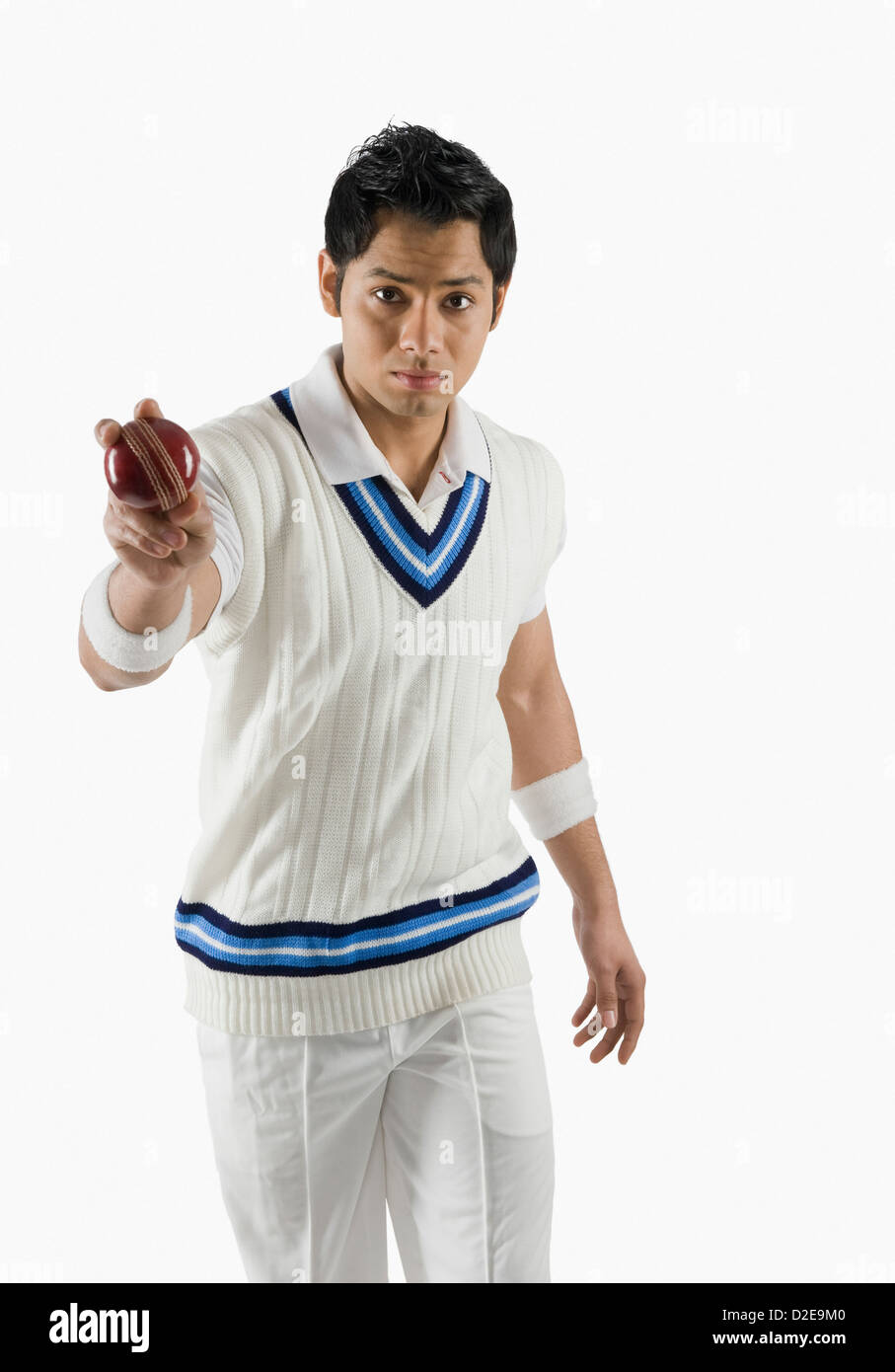 Portrait of a cricket bowler holding a ball Stock Photo - Alamy