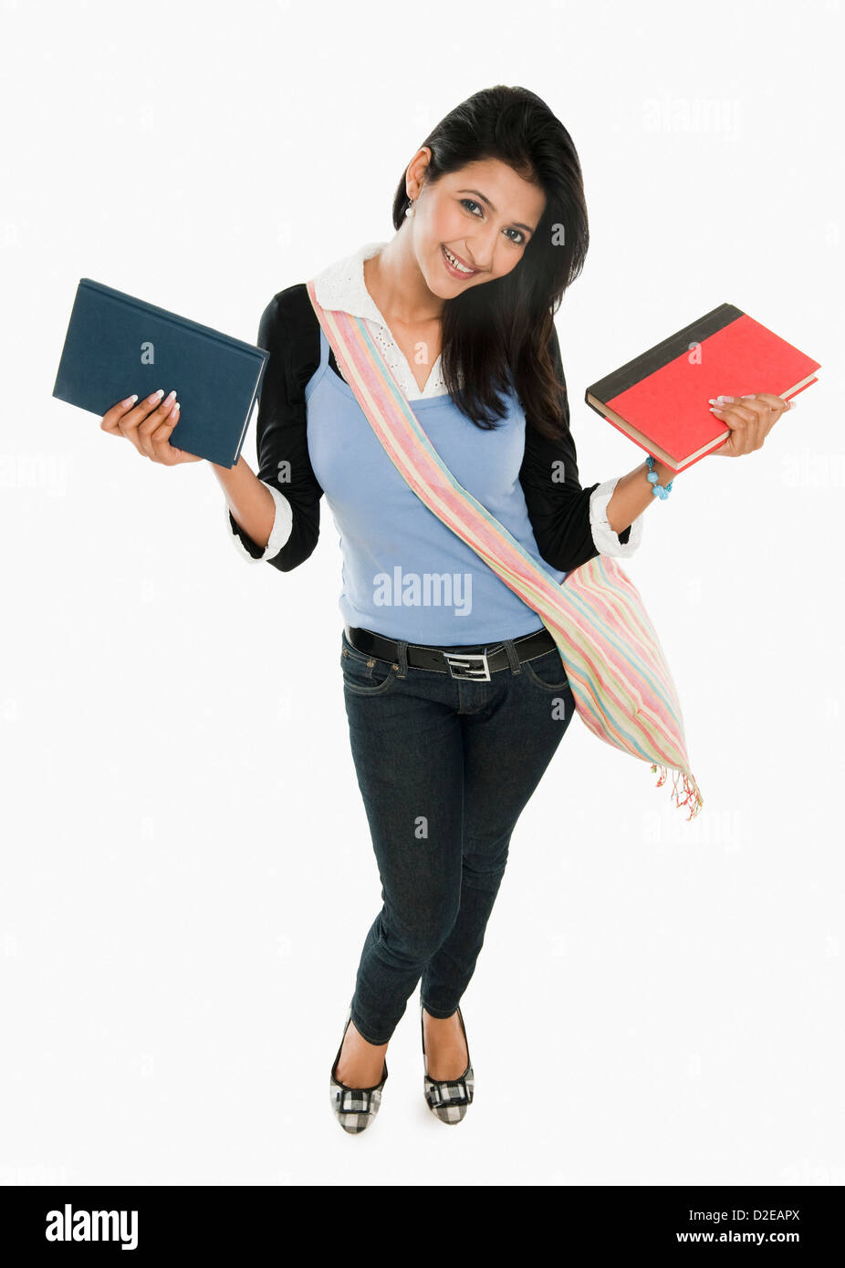 University student holding books and smiling Stock Photo - Alamy