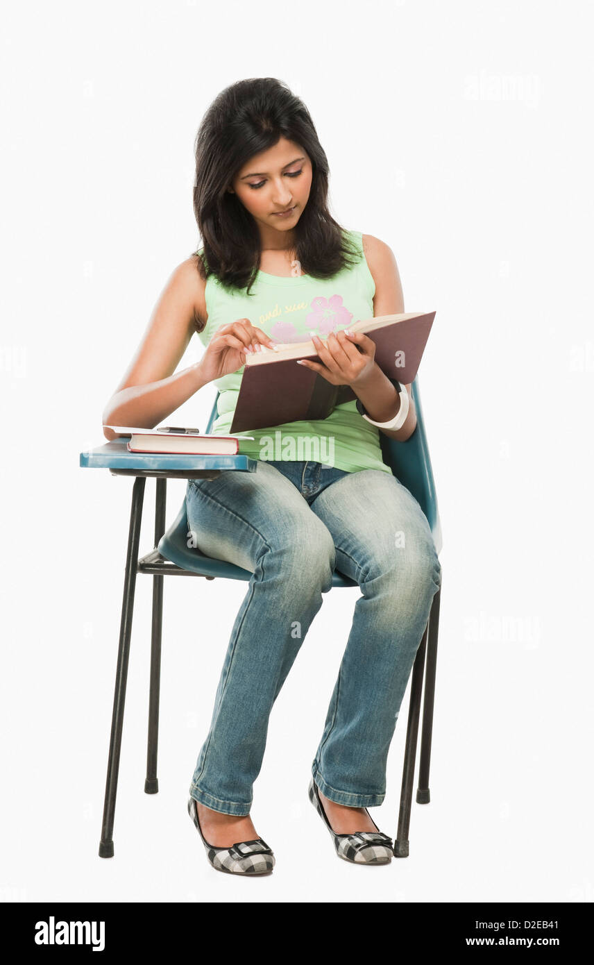 University student reading a book in a classroom Stock Photo - Alamy