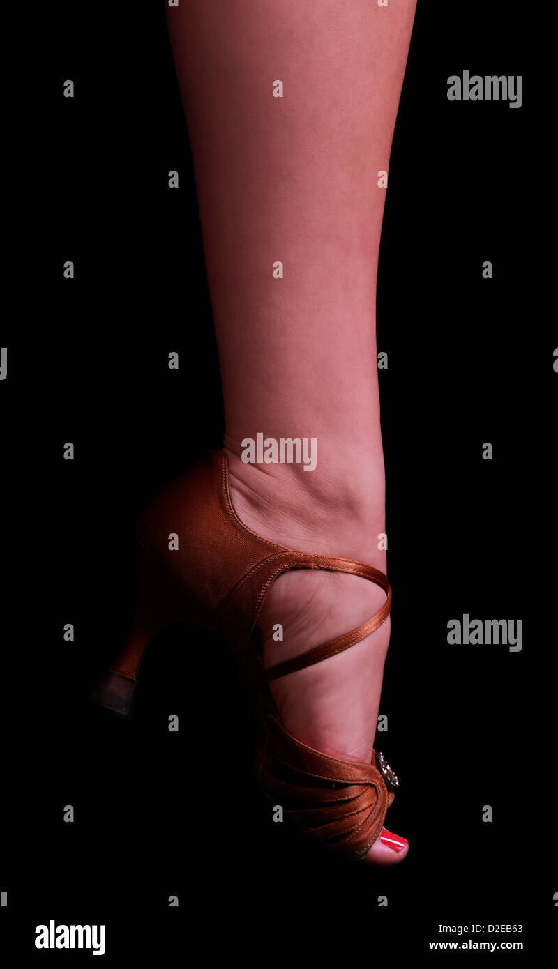 The foot of a female dancer in a high heel dancing sandal isolated ...