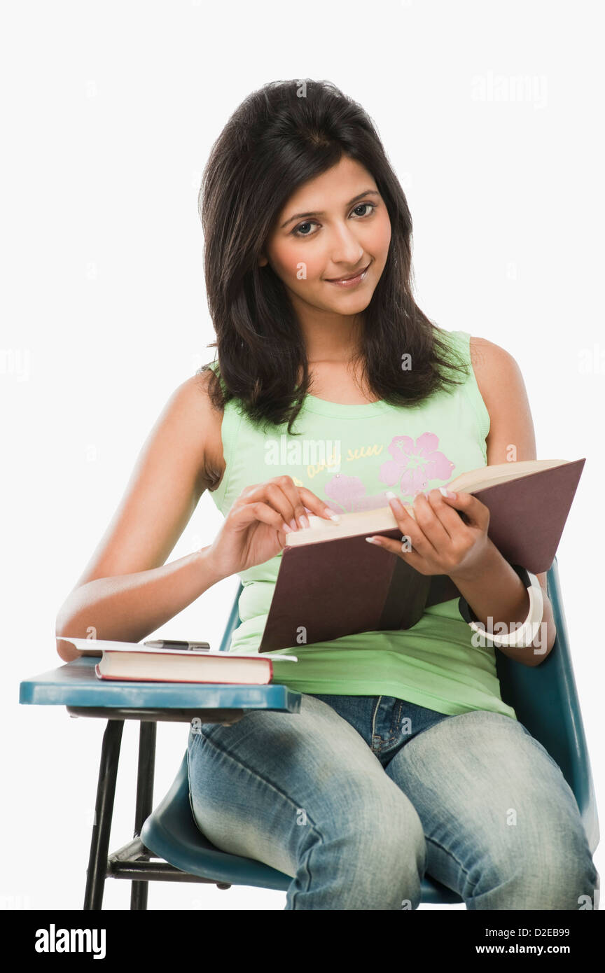 University student reading a book in a classroom Stock Photo - Alamy