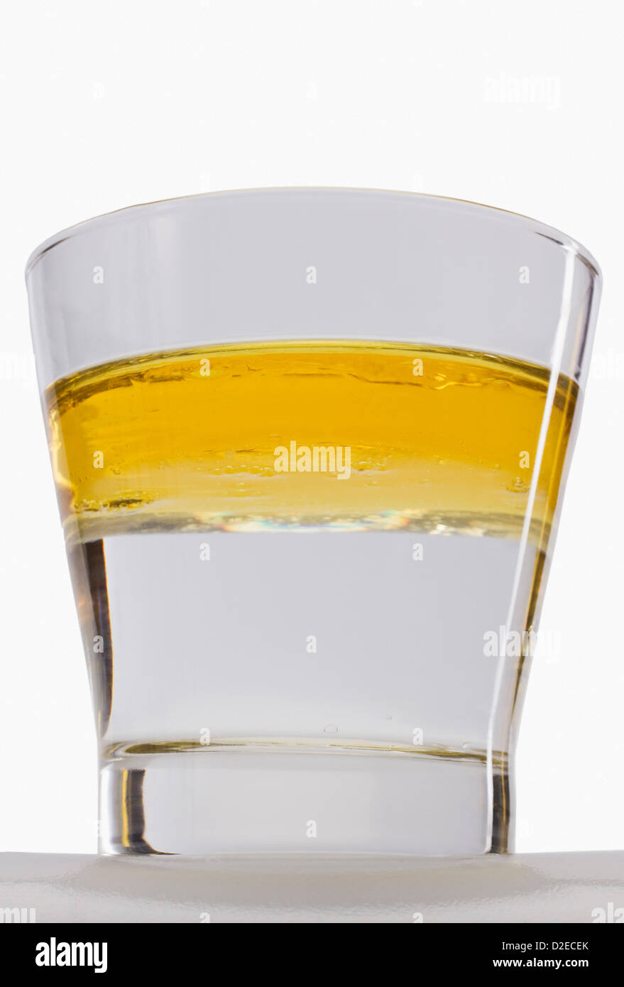 Oil floating on water surface in a glass Stock Photo - Alamy