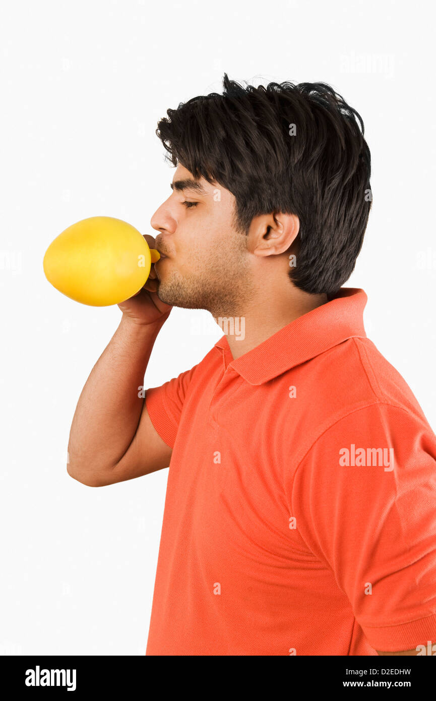 Man blowing up a balloon Stock Photo - Alamy