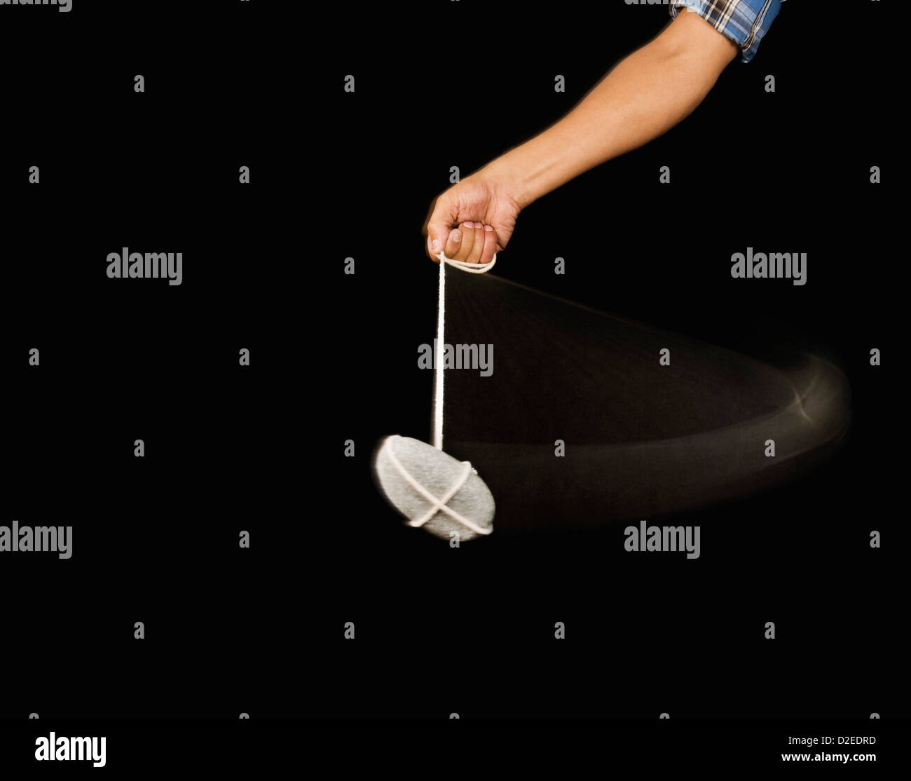 Close-up of a person's hand swinging a stone pendulum Stock Photo - Alamy