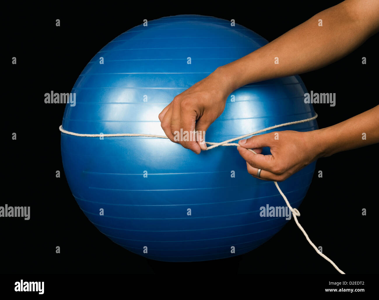 Close-up of a man measuring a curved surface with a string Stock Photo ...
