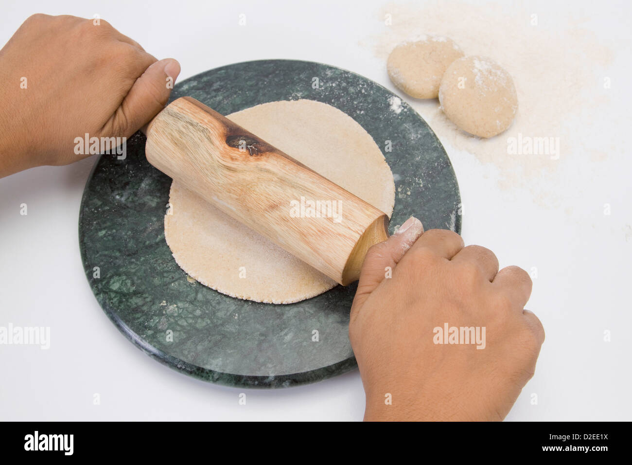 Person's hands rolling dough with a rolling pin Stock Photo - Alamy