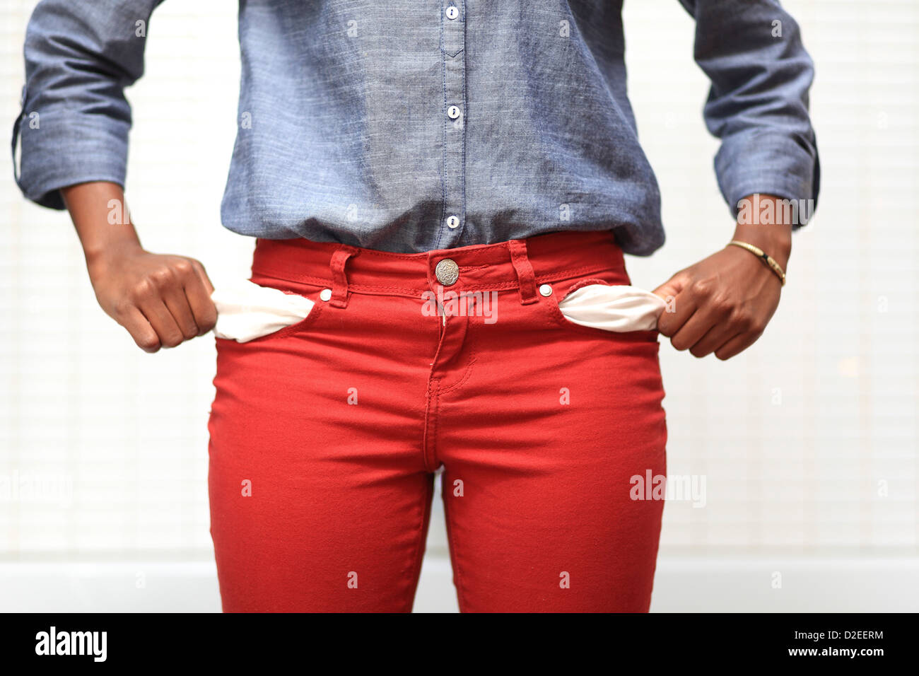 France, young woman at home with empty pockets Stock Photo - Alamy