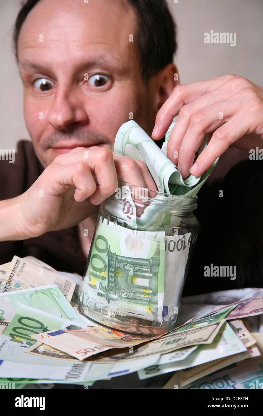 The adult the man with money in bank Stock Photo - Alamy