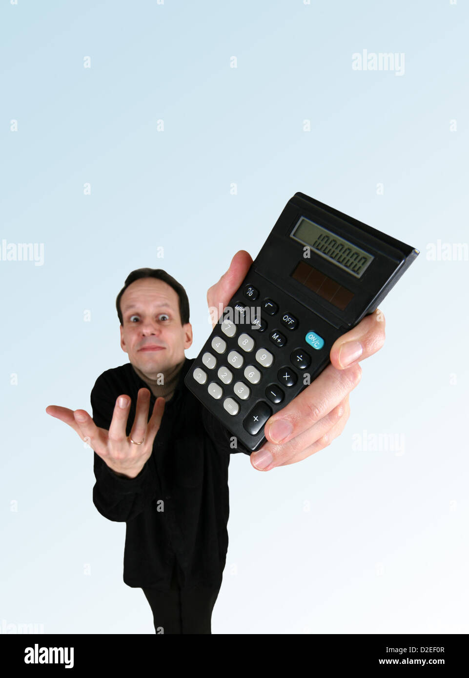 Adult man in black suit with calculator in hand on white background ...