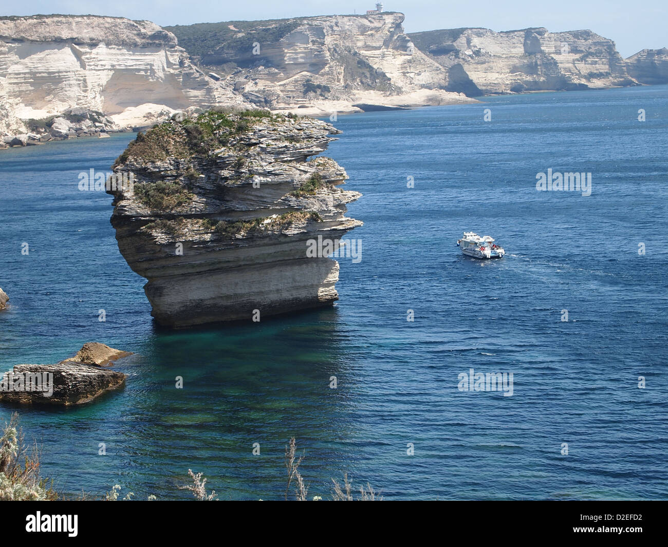 A mighty rock in an azure sea Stock Photo - Alamy