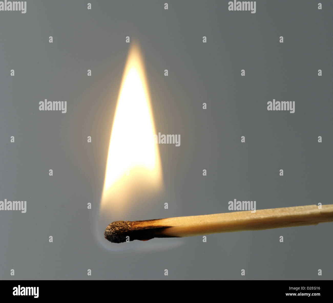 Lit match, gray background Stock Photo - Alamy