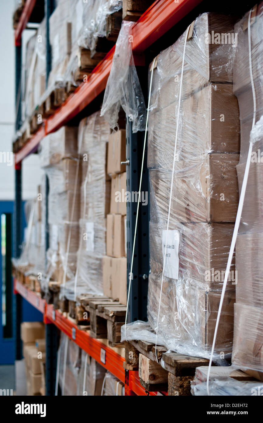 Boxes aligned on shelves in a warehouse Stock Photo - Alamy