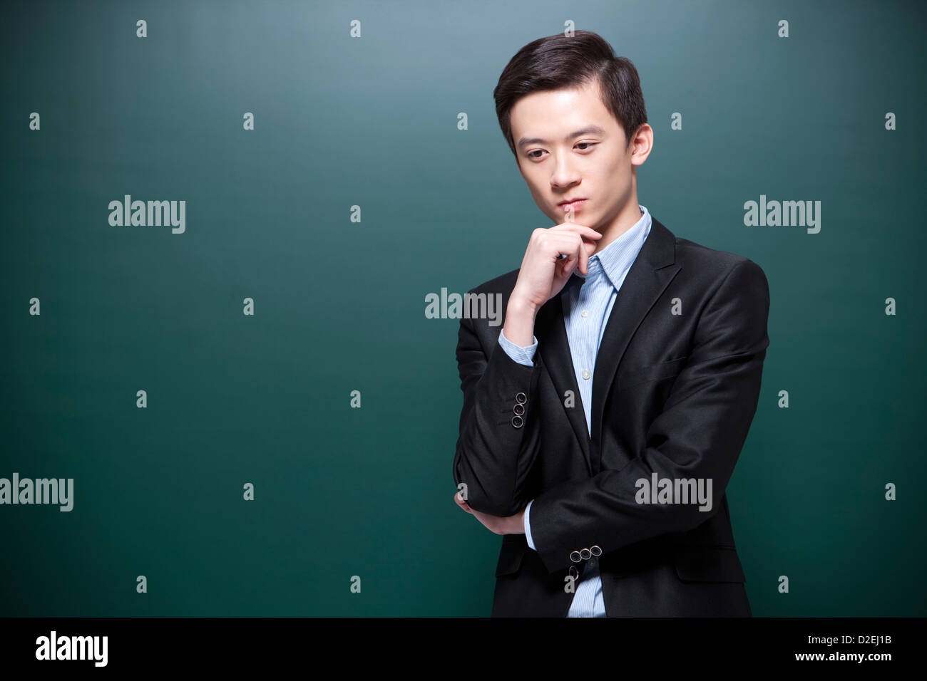 Serious male teacher hand on chin Stock Photo - Alamy