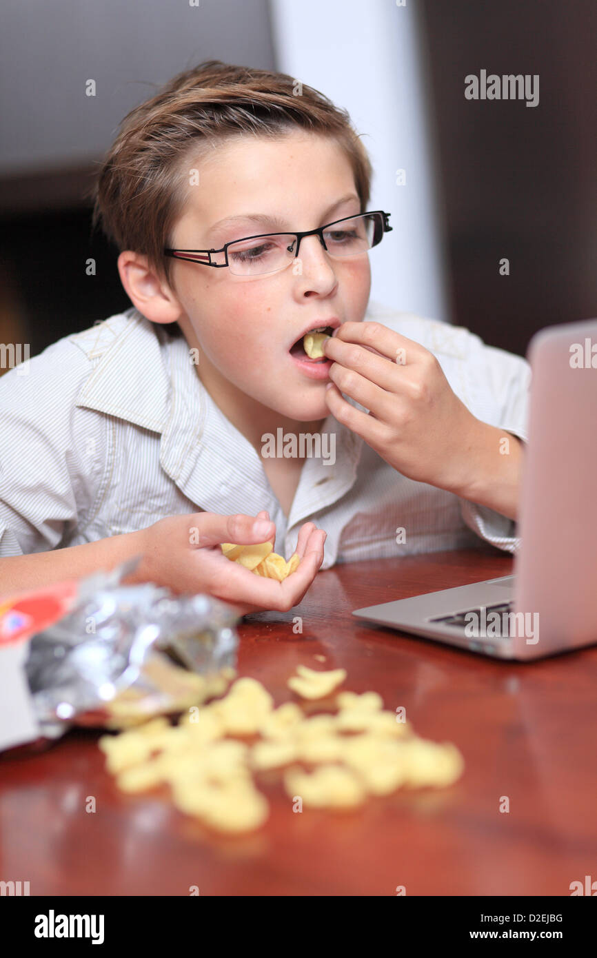 France, young boy with a computer and chips Stock Photo - Alamy