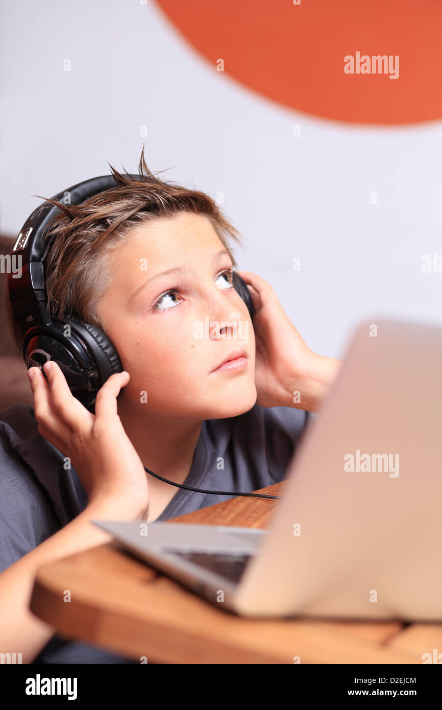 France, boy listening to music with a computer Stock Photo - Alamy