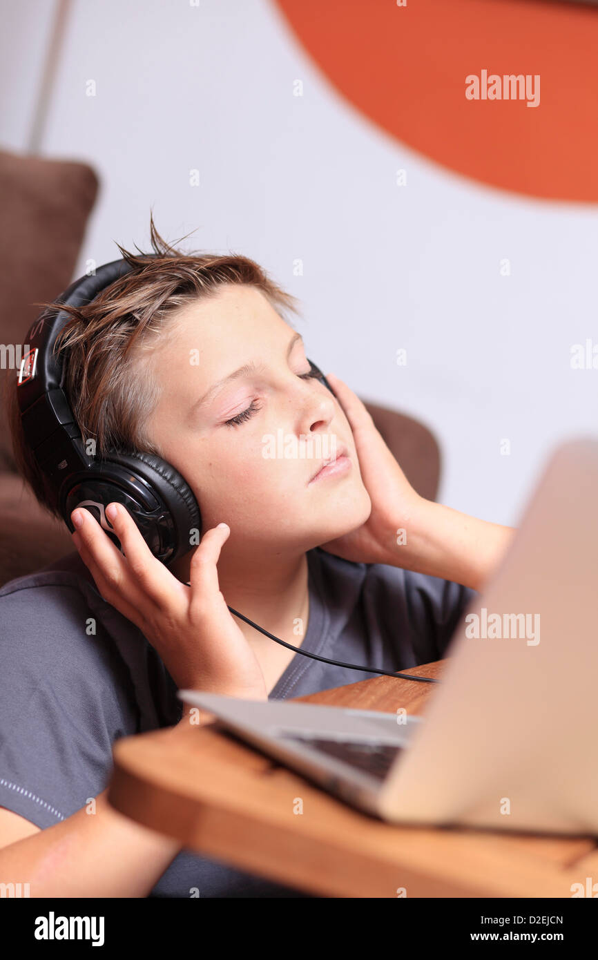 France, boy listening to music with a computer Stock Photo - Alamy