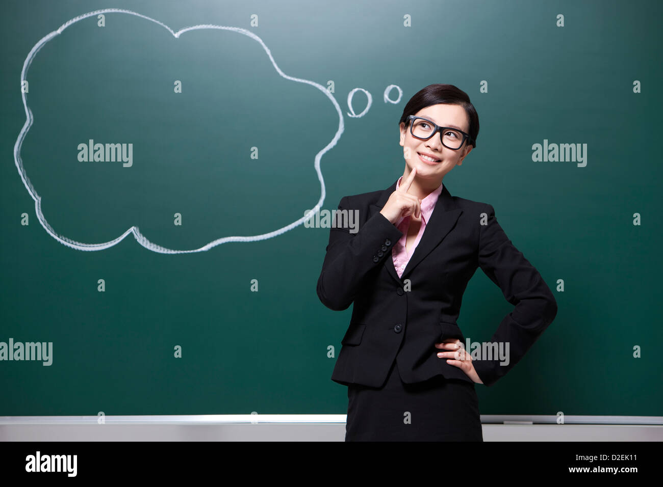 Professional female teacher hand on chin in classroom Stock Photo - Alamy