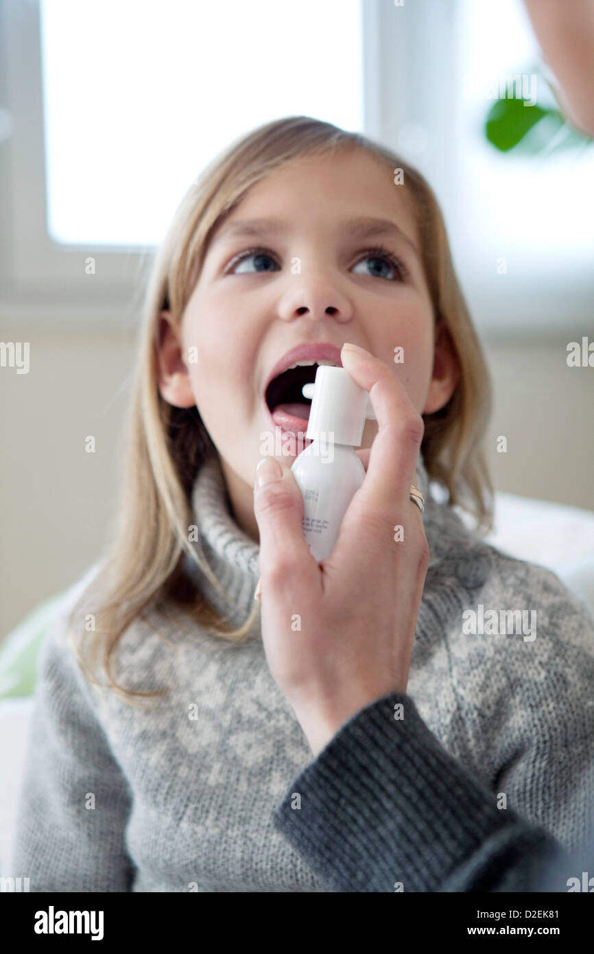 CHILD USING SPRAY IN MOUTH Stock Photo - Alamy