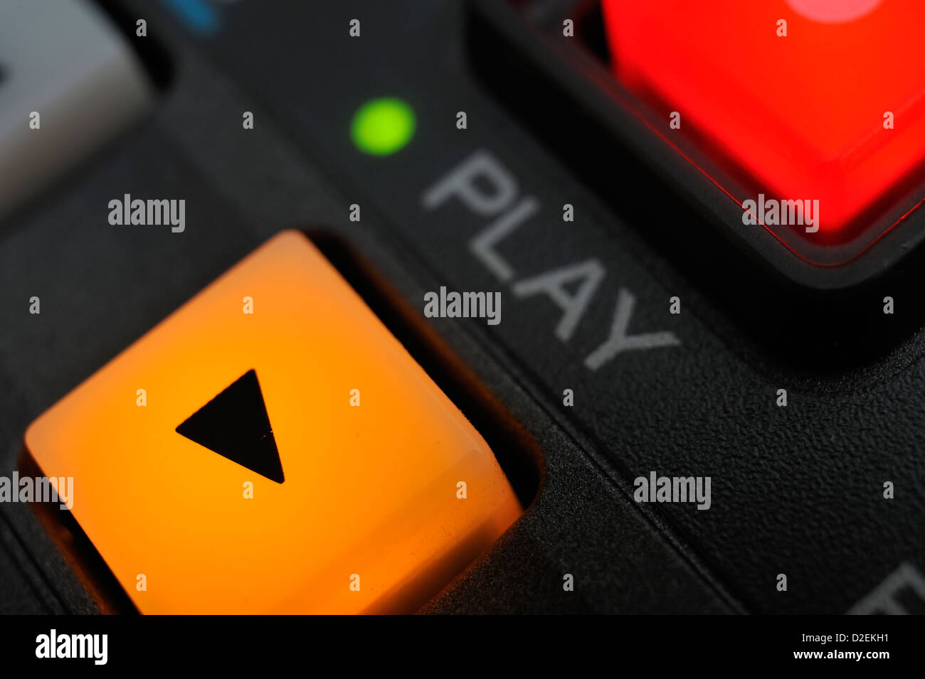 Macro shot of the yellow color "Play" button and a piece of red "Record ...