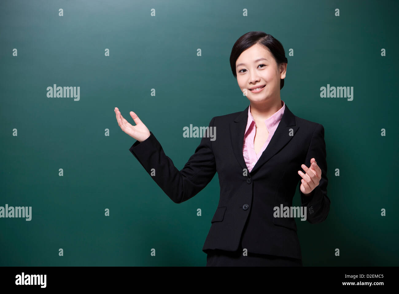 Happy female teacher giving a lesson in classroom Stock Photo - Alamy