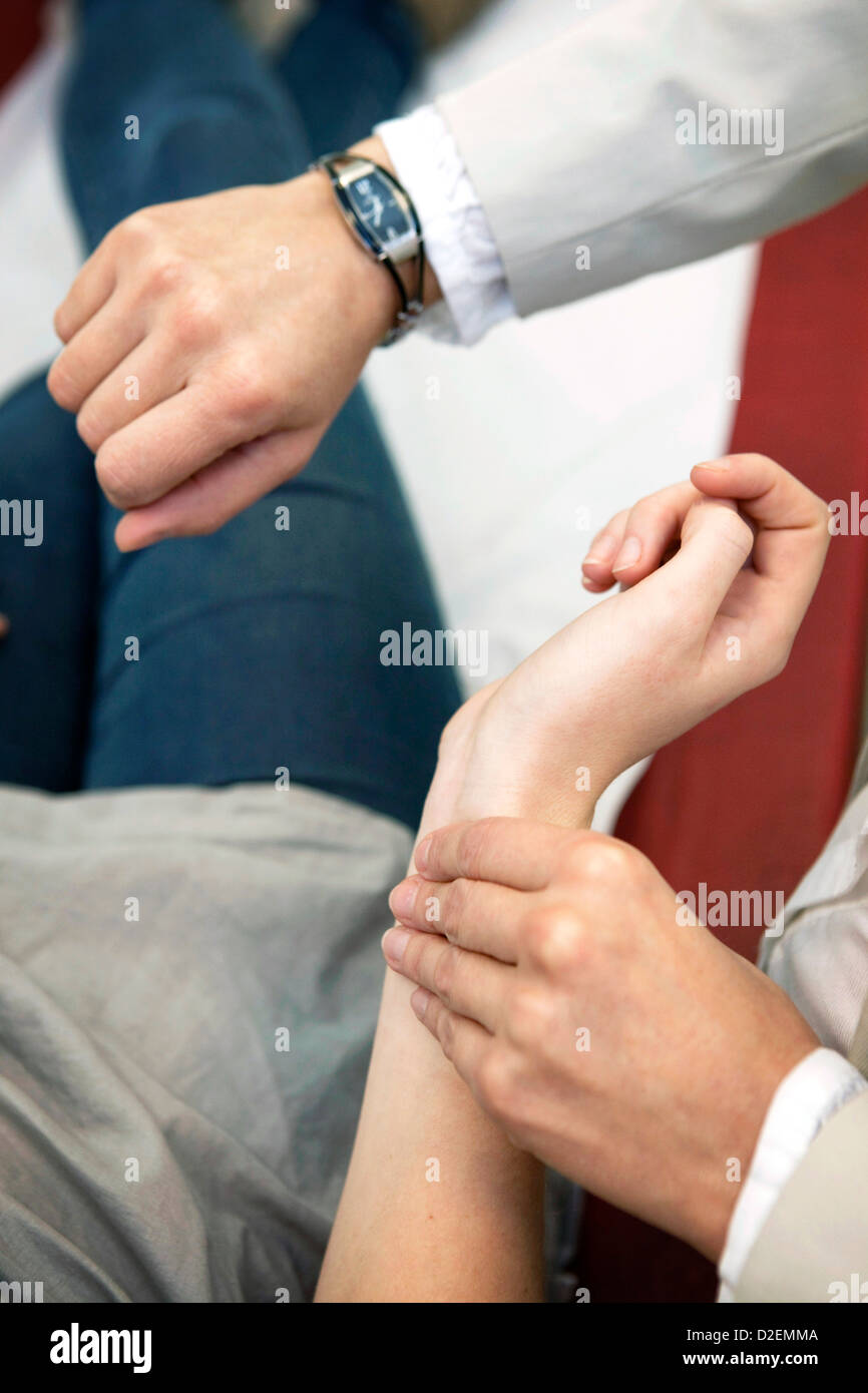 TAKING A WOMAN'S PULSE Stock Photo - Alamy