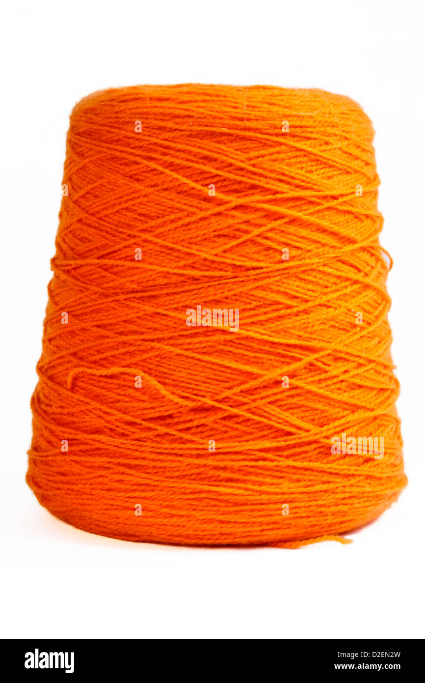 Cone of orange coloured machine knitting wool Stock Photo - Alamy