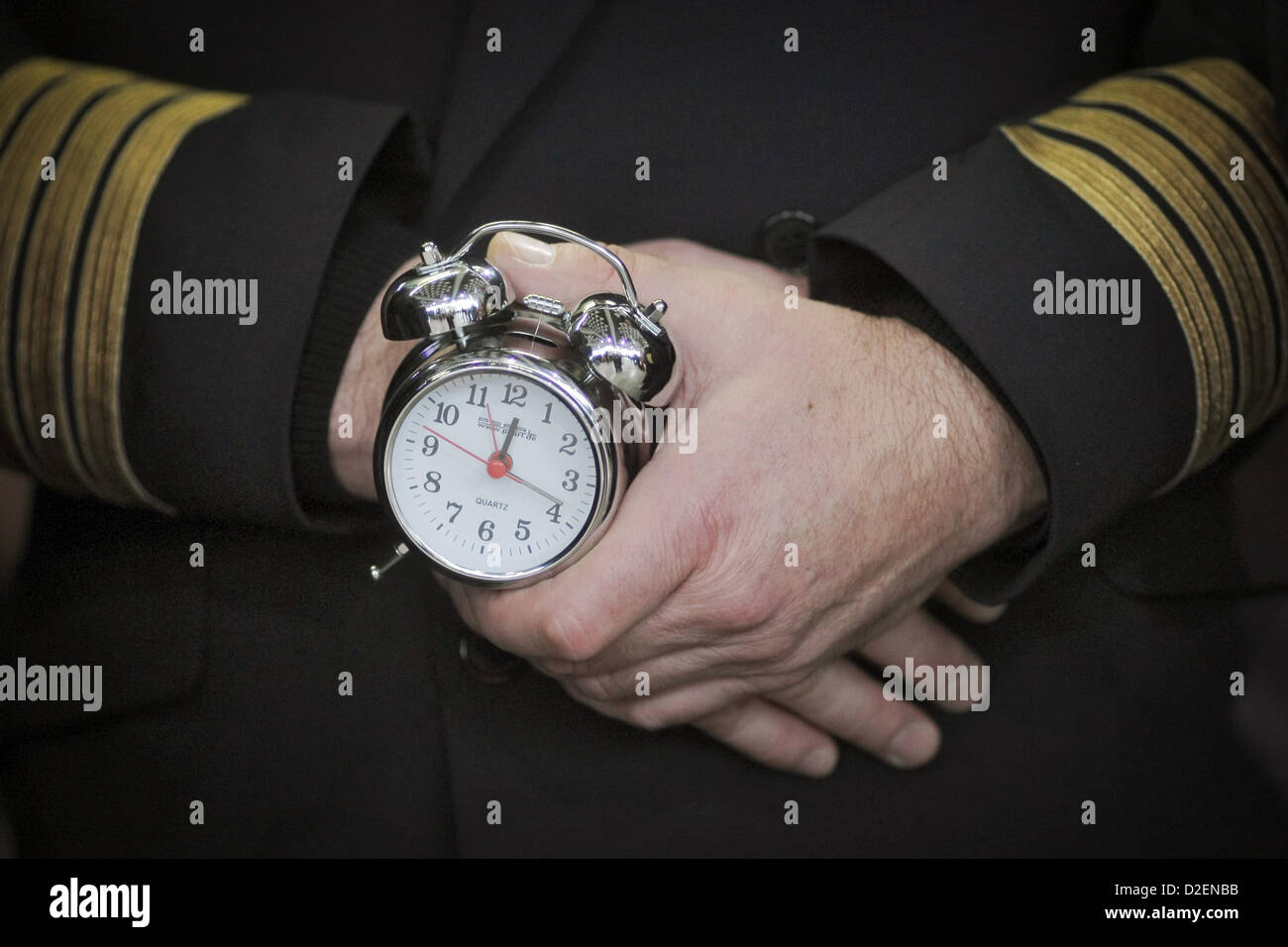 Pilot demonstrates for more security with an alarm clock in his hand on ...