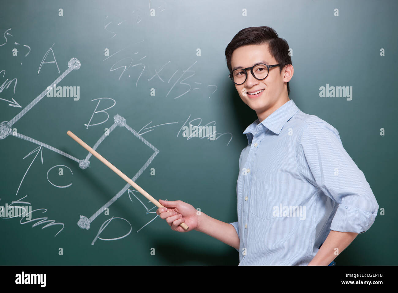 Confident Male teacher giving lessons in classroom Stock Photo - Alamy