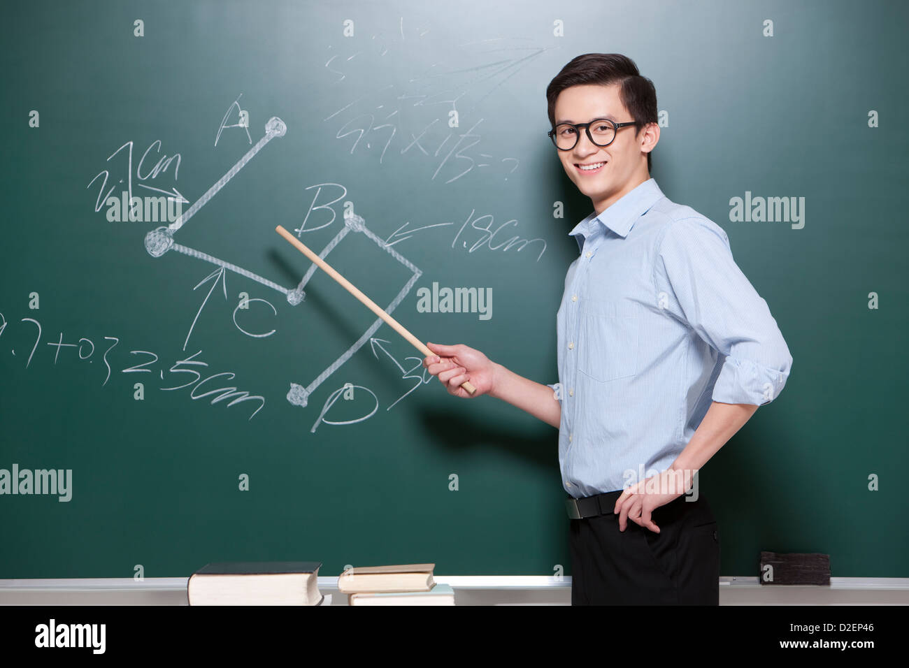 Confident Male teacher giving lessons in classroom Stock Photo - Alamy