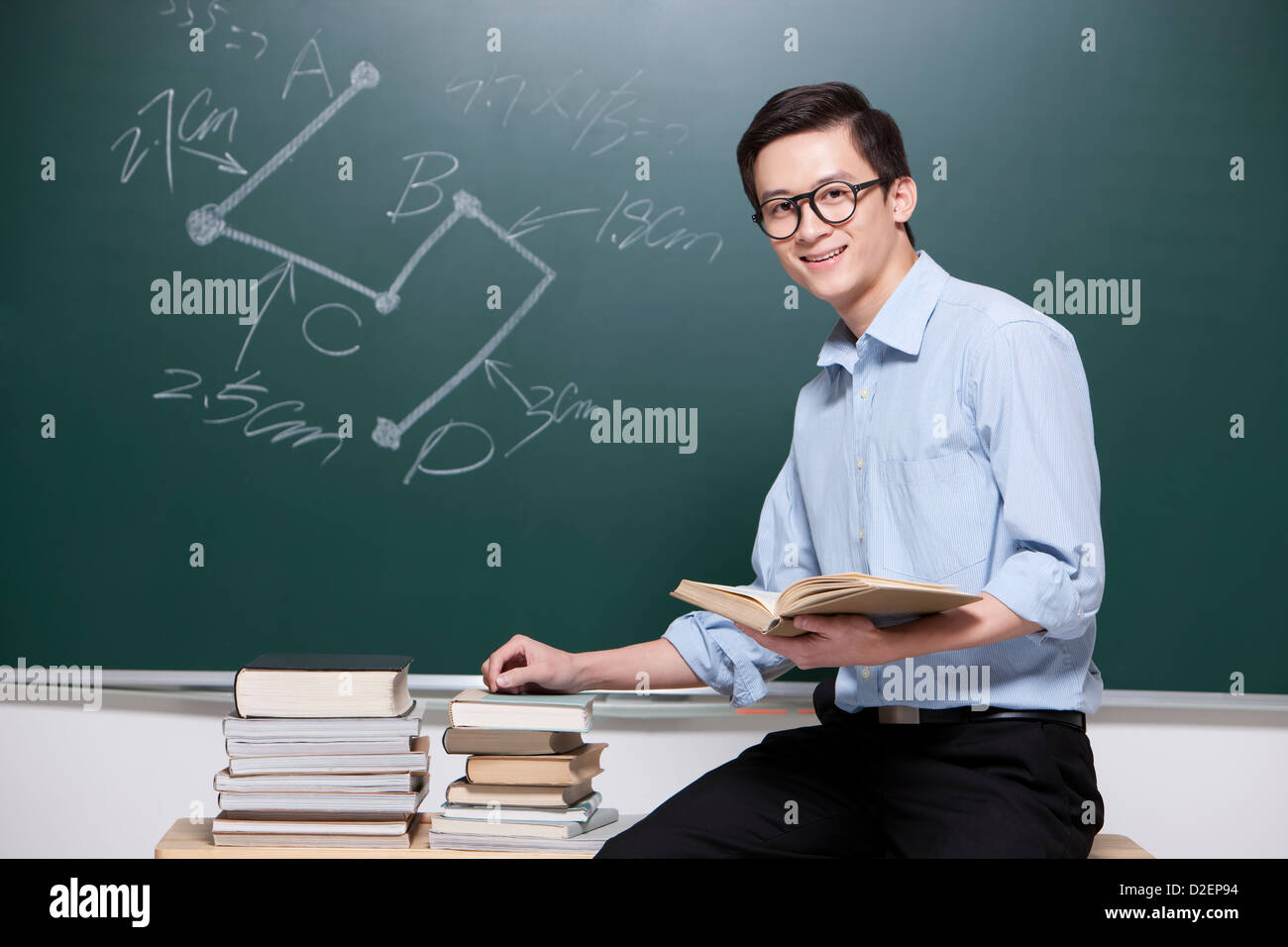 Confident Male teacher giving lessons in classroom Stock Photo - Alamy