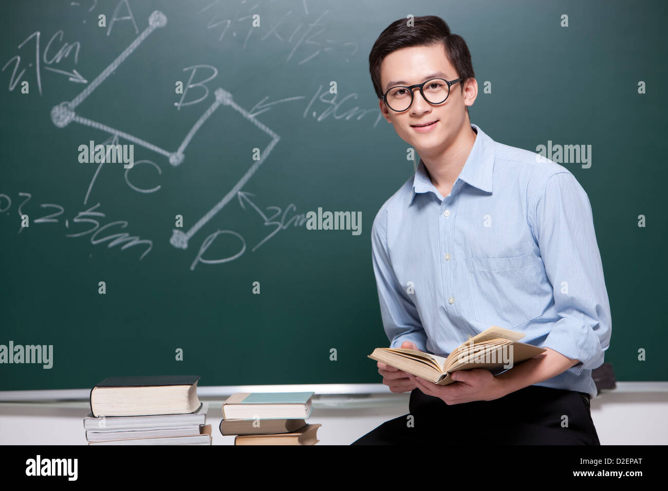Confident Male teacher giving lessons in classroom Stock Photo - Alamy