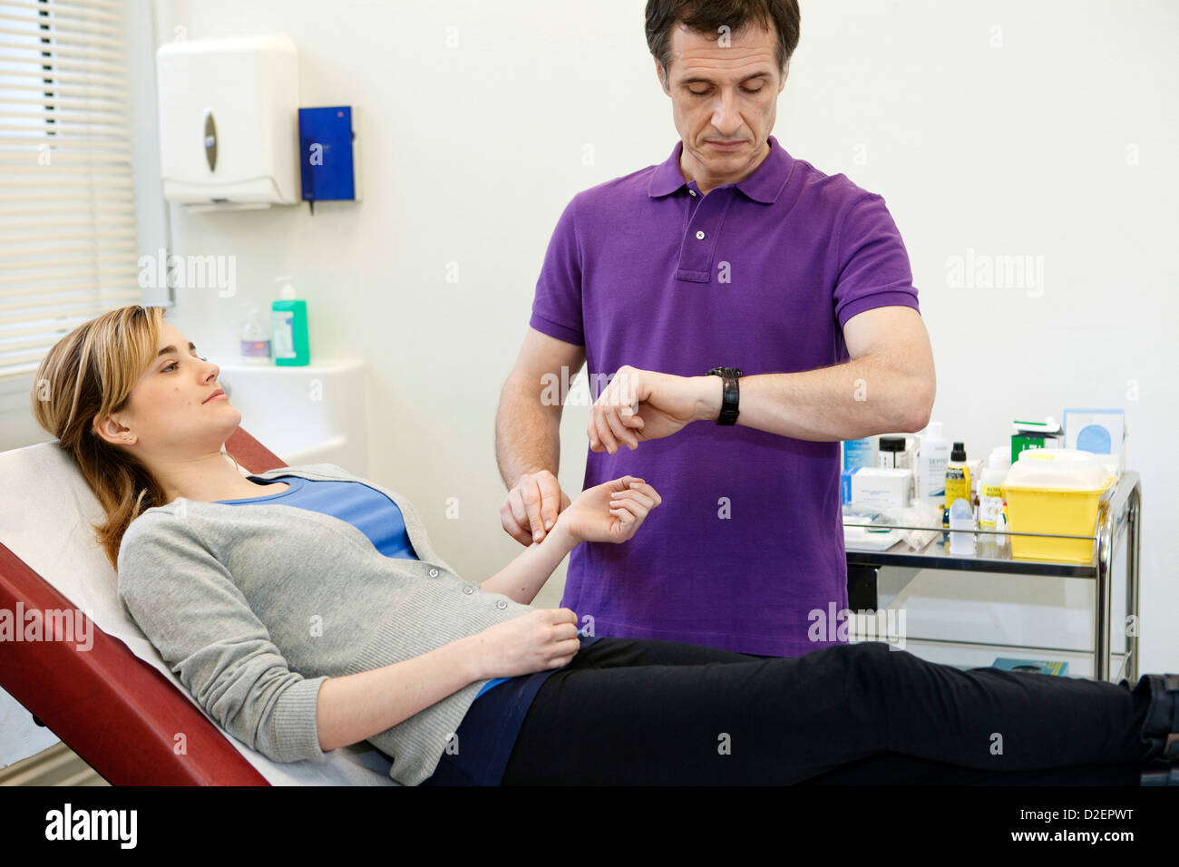 TAKING A WOMAN'S PULSE Stock Photo - Alamy